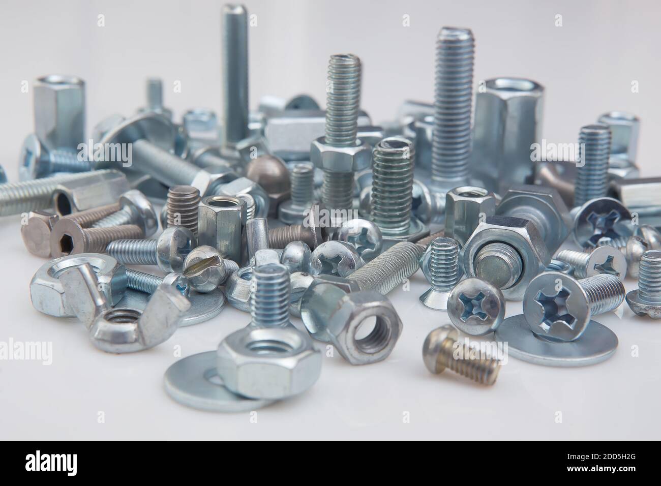 chromeplated bolts and nuts on white background Stock Photo - Alamy