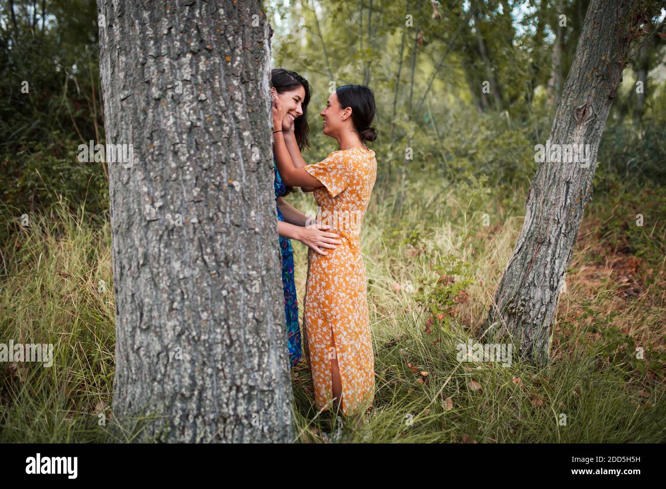 Two young lesbians kissing and caressing each other in the woods Stock Photo - Alamy