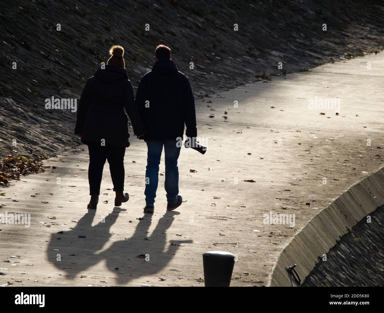 Silhouette of a Middle Aged Pair on a Walk with Camera Stock Photo - Alamy