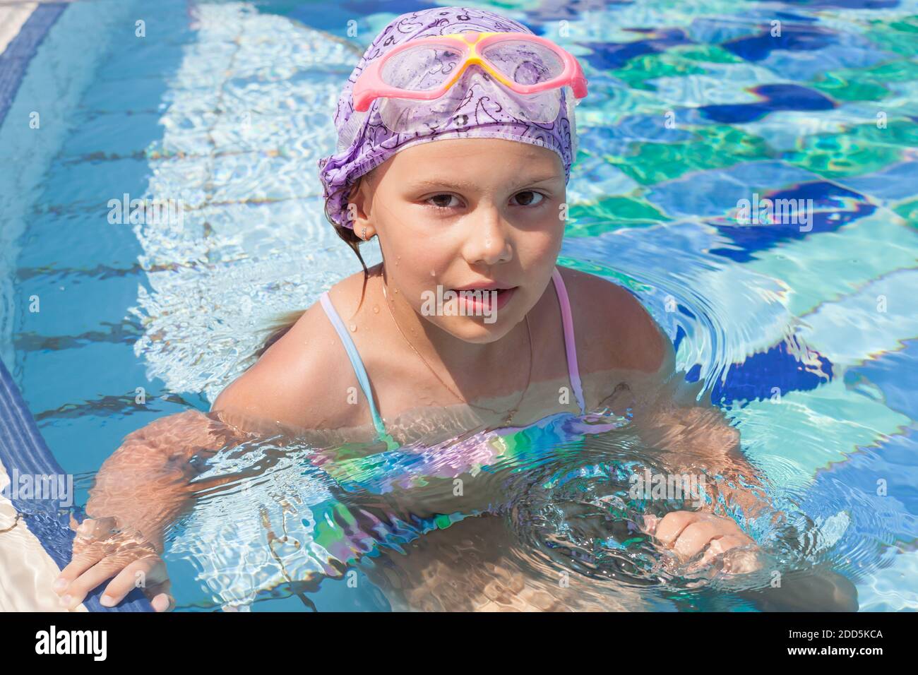 Happy Caucasian little girl is in swimming pool at sunny day, outdoor ...