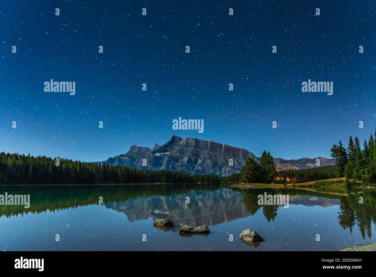 Beautiful full of stars above Mount Rundle from Two Jack Lake at night ...
