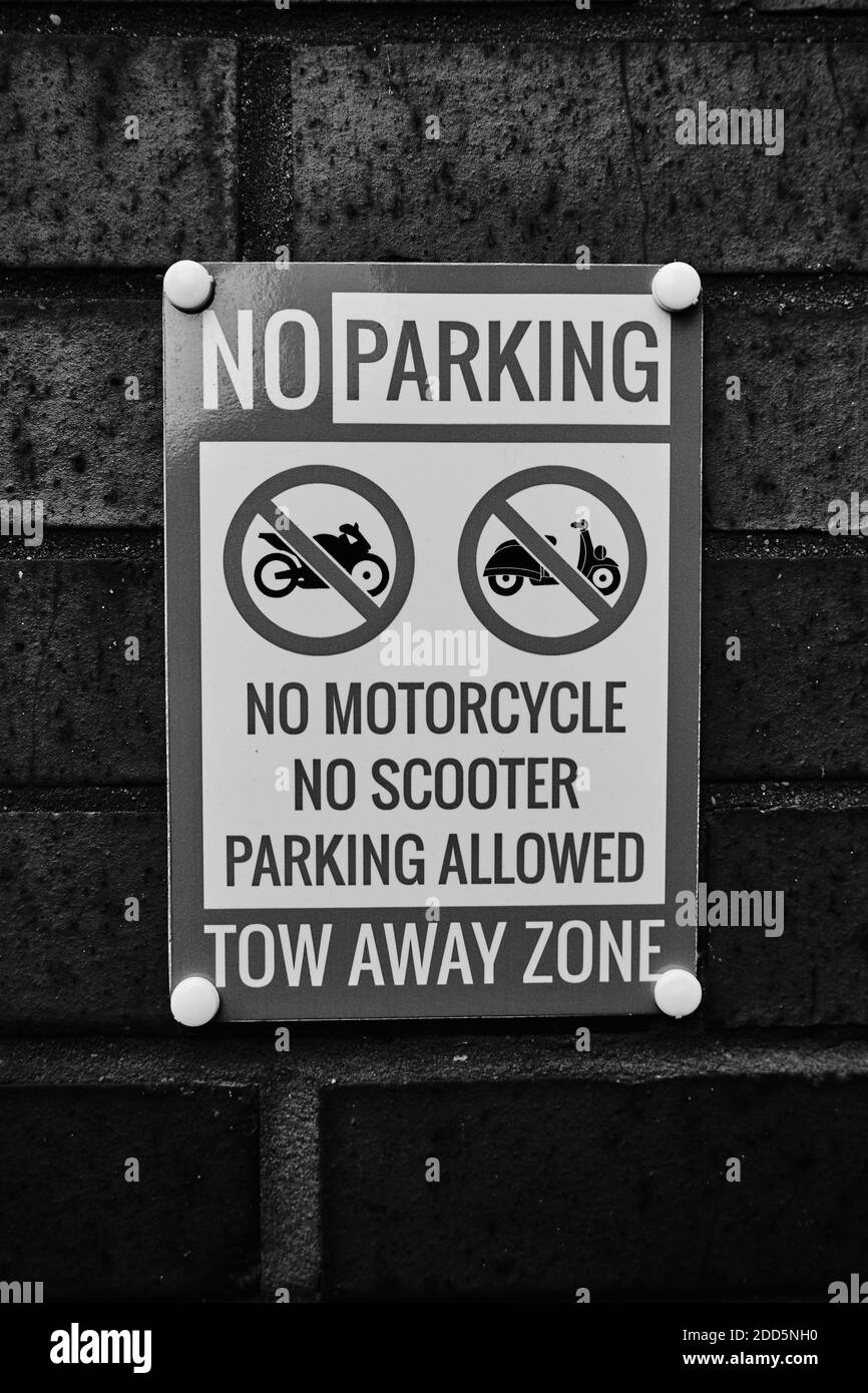 No parking, no motorbikes no scooters, black and white street sign ...