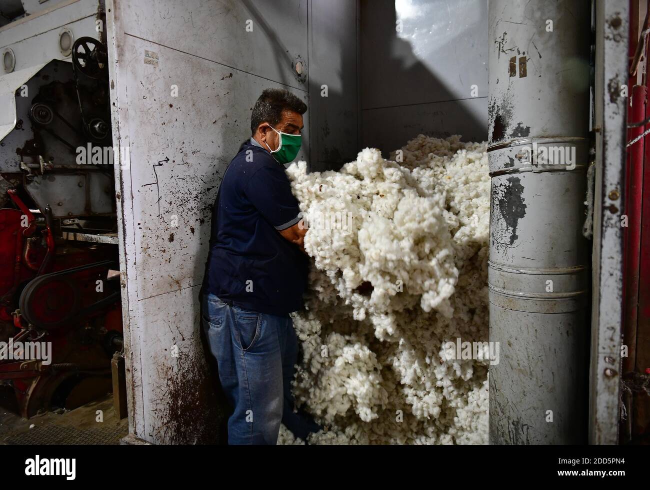 Hama, Syria. 26th Oct, 2020. A worker processes cotton at a government ...