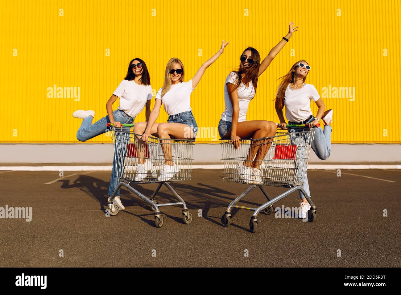 Group of happy young people having fun on shopping carts, young people ...