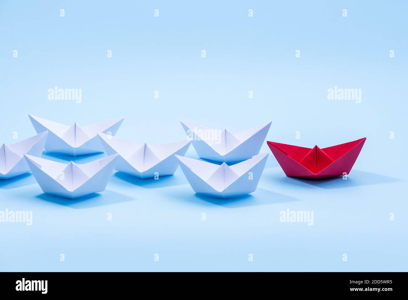 Red and white paper boats. Concept of leadership boats for teamwork ...