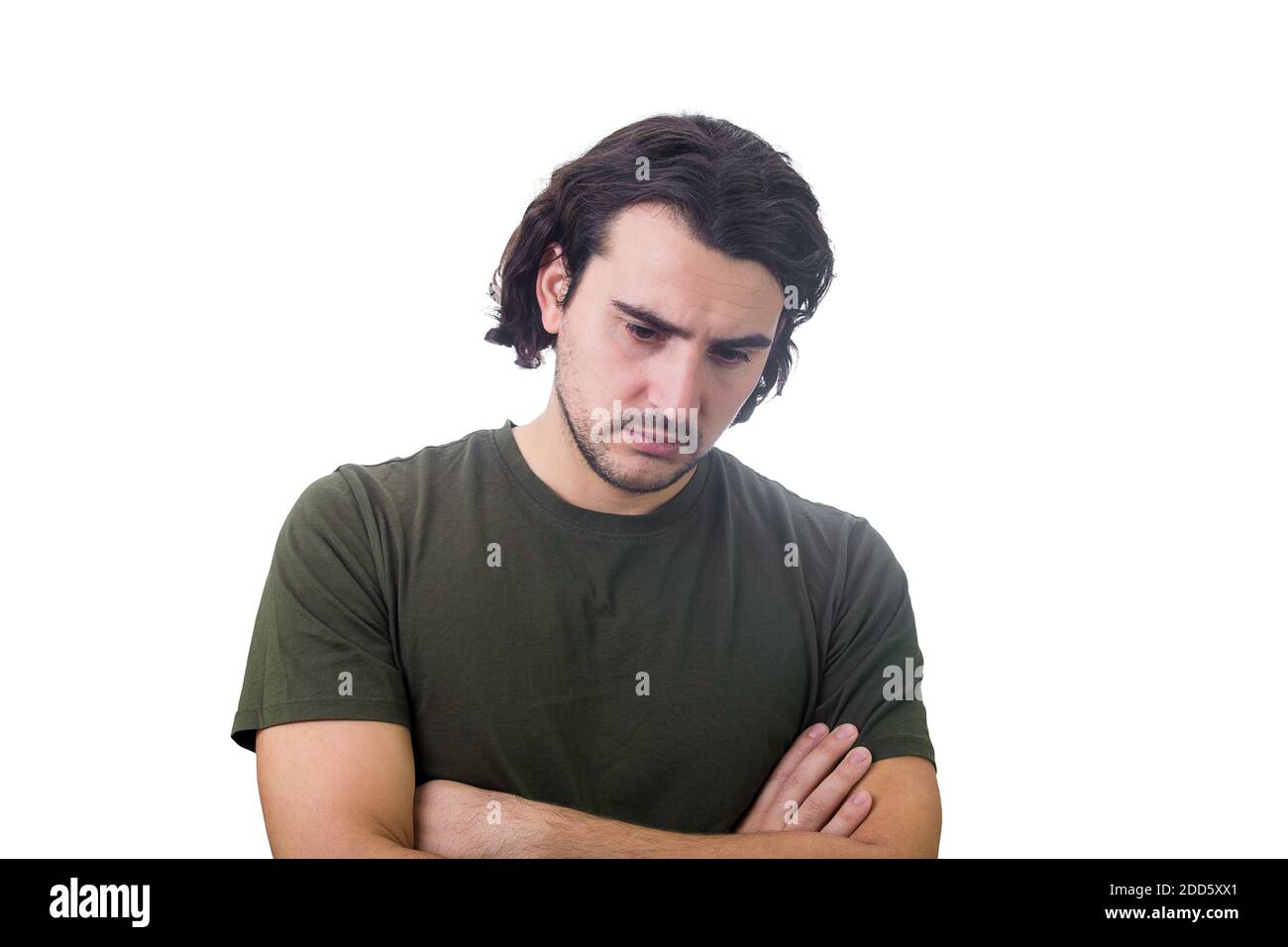 Disappointed and annoyed young man makes a displeased facial expression ...