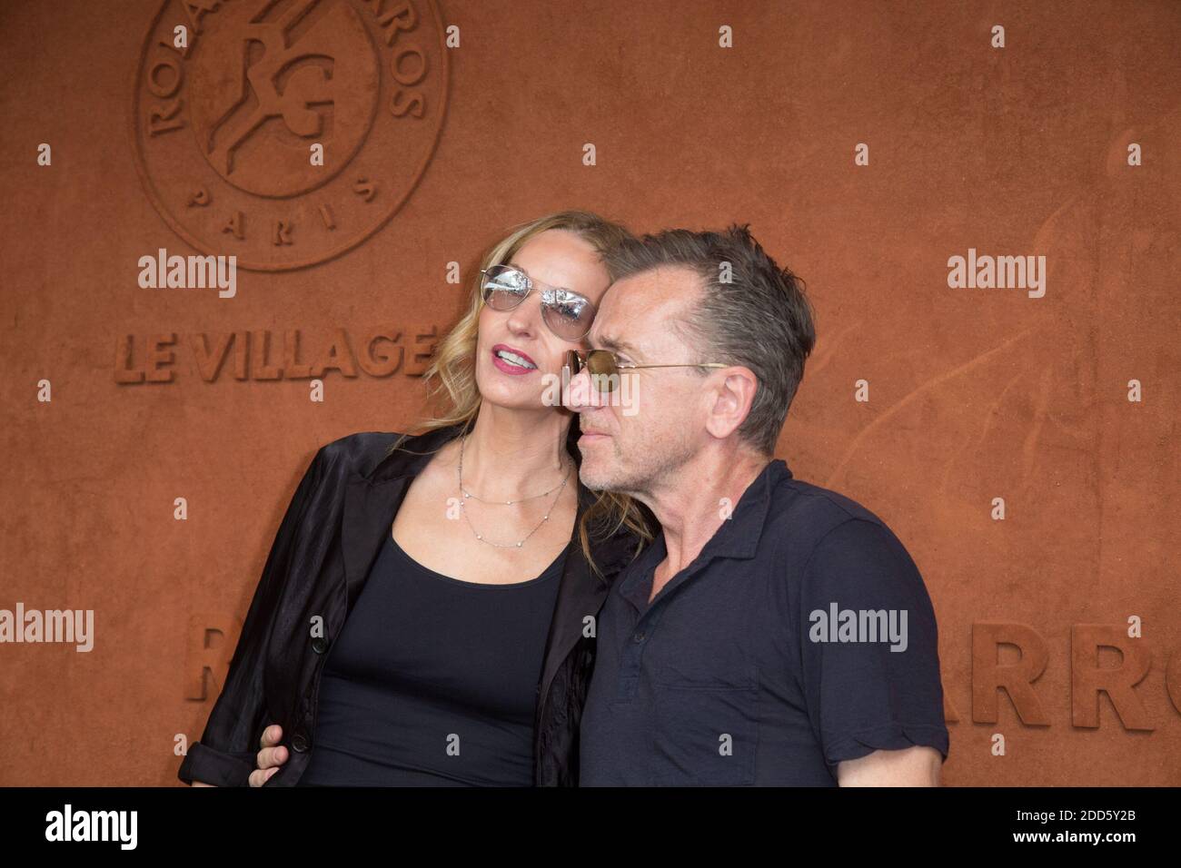 Tim Roth and wife Nikki Butler in Village during French Tennis Open at ...