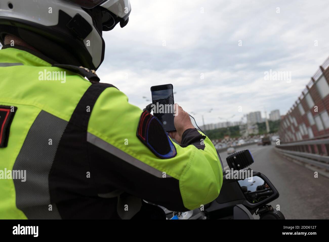 Road police officer sitting on a bike and taking photo of traffic Stock ...