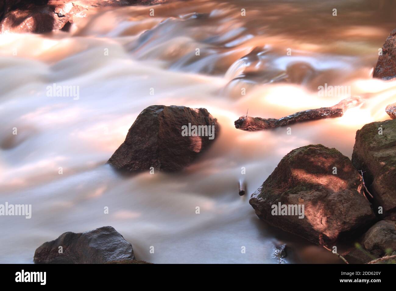 wild stream in nature reserve, weir water and rocks Stock Photo - Alamy