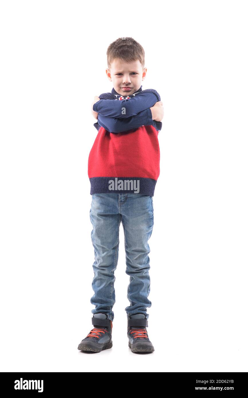 Displeased angry cute young kid with crossed hands frowning and looking ...