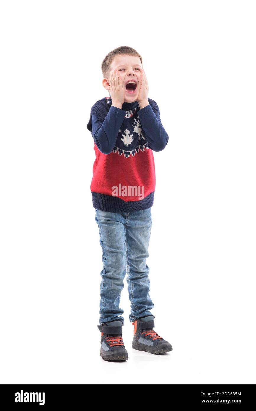 Loud laughing young boy screaming with hands on face looking up in ...