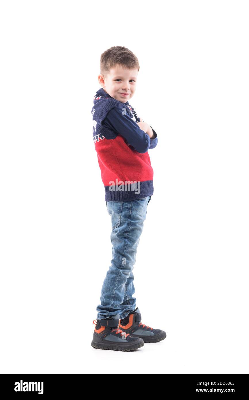 Side view of cool kid confident young boy posing with crossed arms ...