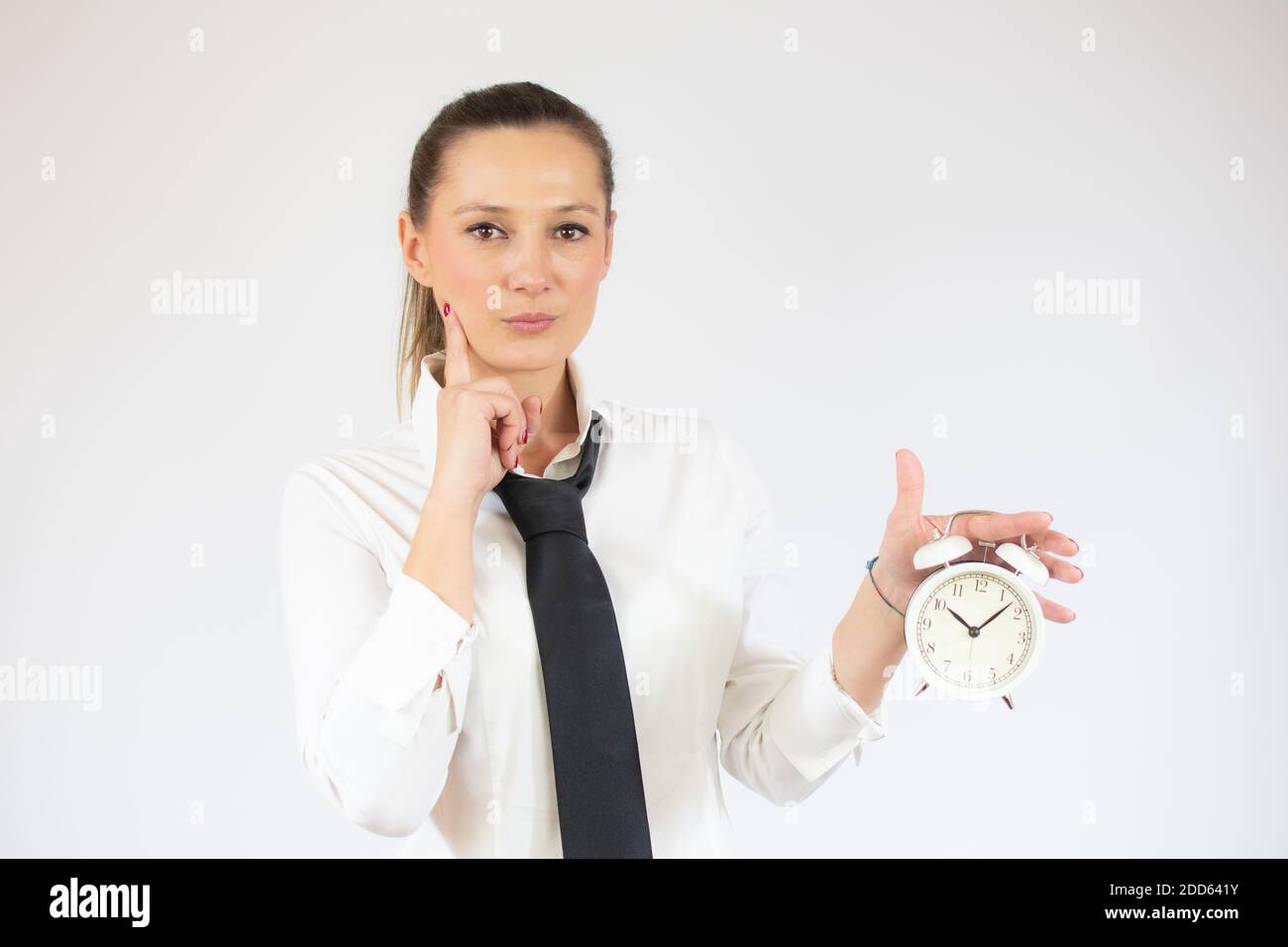 Business caucasian woman holding alarm clock thinking on a white ...