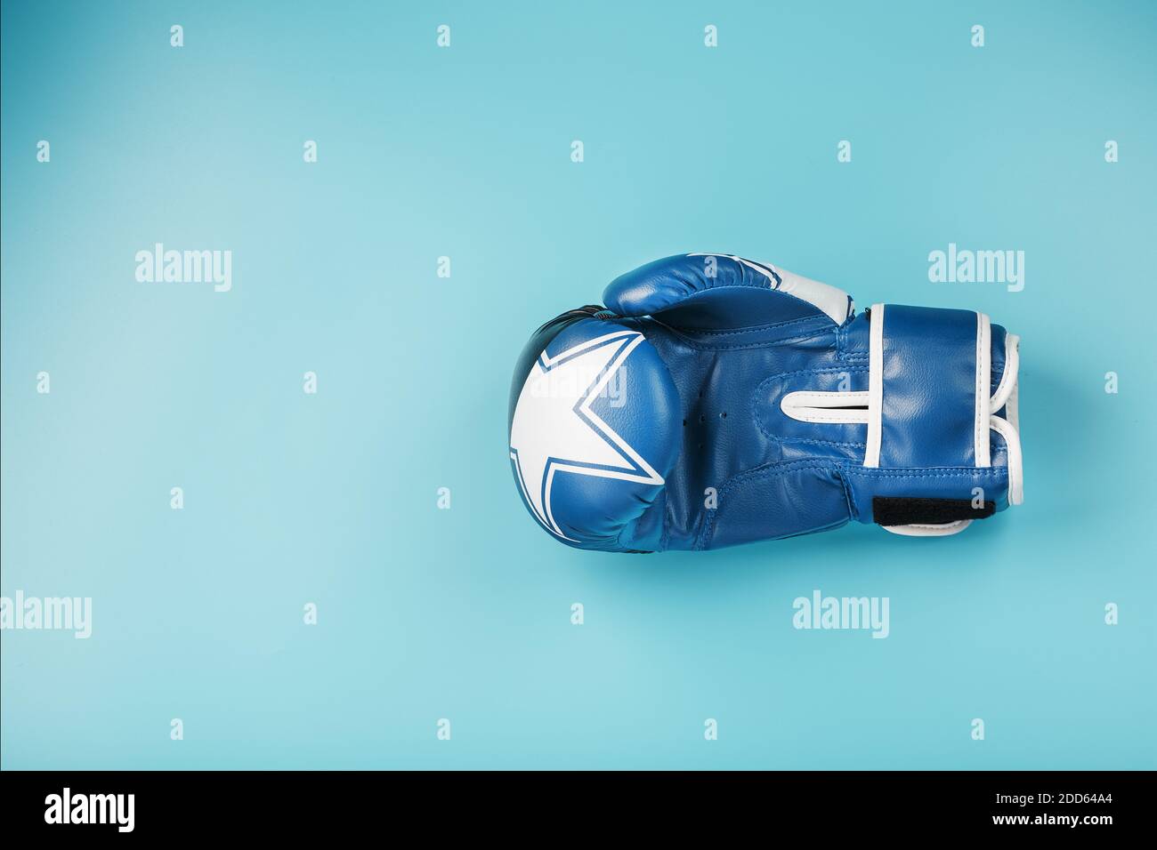 Blue Boxing glove on a blue background, free space. The concept of ...