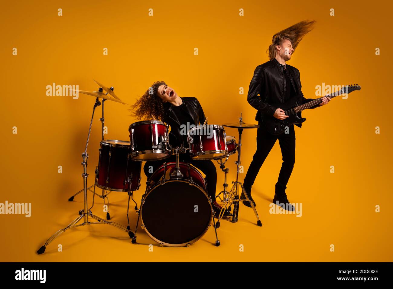 Full body photo of rock group cool guy play guitar crazy girl beat drum ...