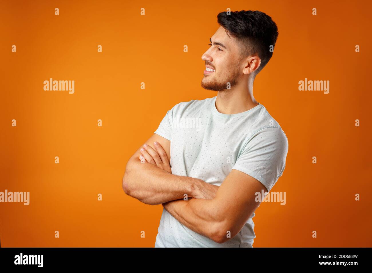 Young positive man in white casual shirt standing with happy smile ...