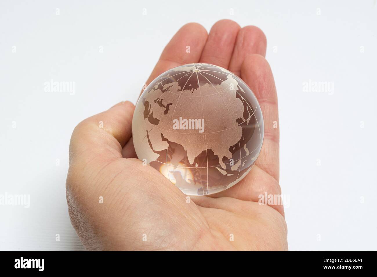 Hand in hand holding a globe hi-res stock photography and images - Alamy