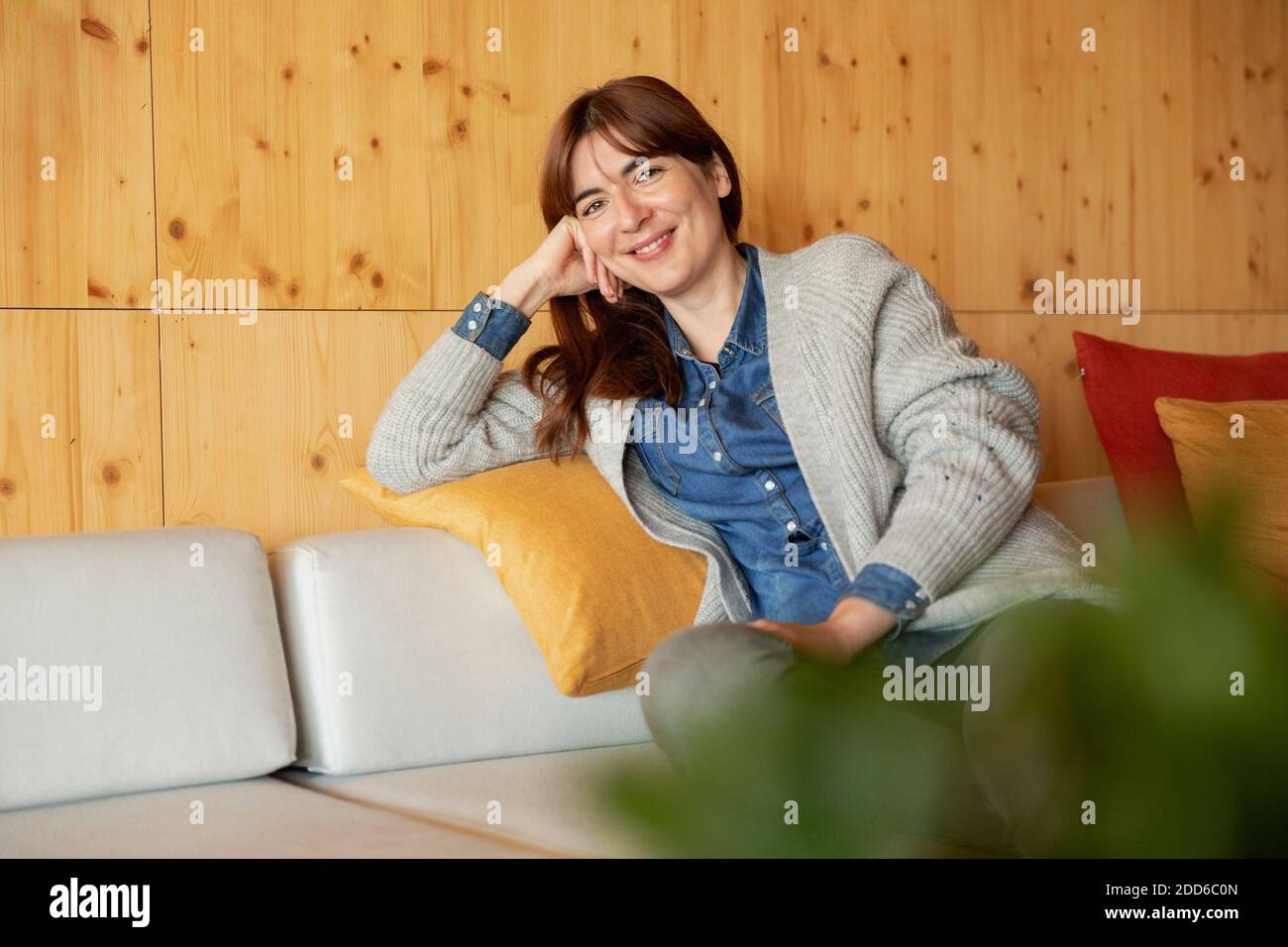 Beautiful woman sitting and relaxing on a cozy place Stock Photo - Alamy