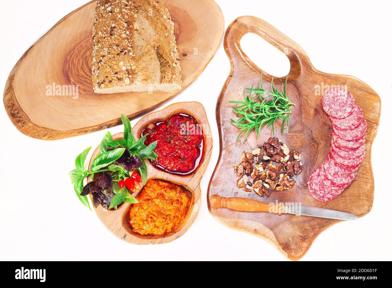 Balkan meze consisting of two types of red pepper spread, bread ...