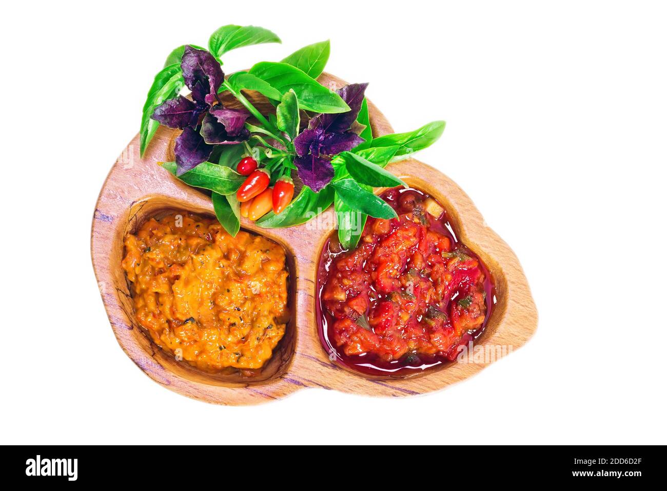 Balkan meze consisting of two types of red pepper spread, bread ...