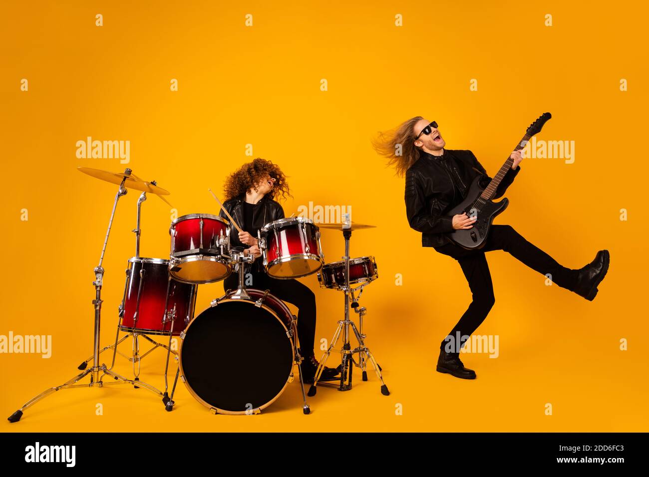 Full length photo funky crazy two people rock group team woman play ...