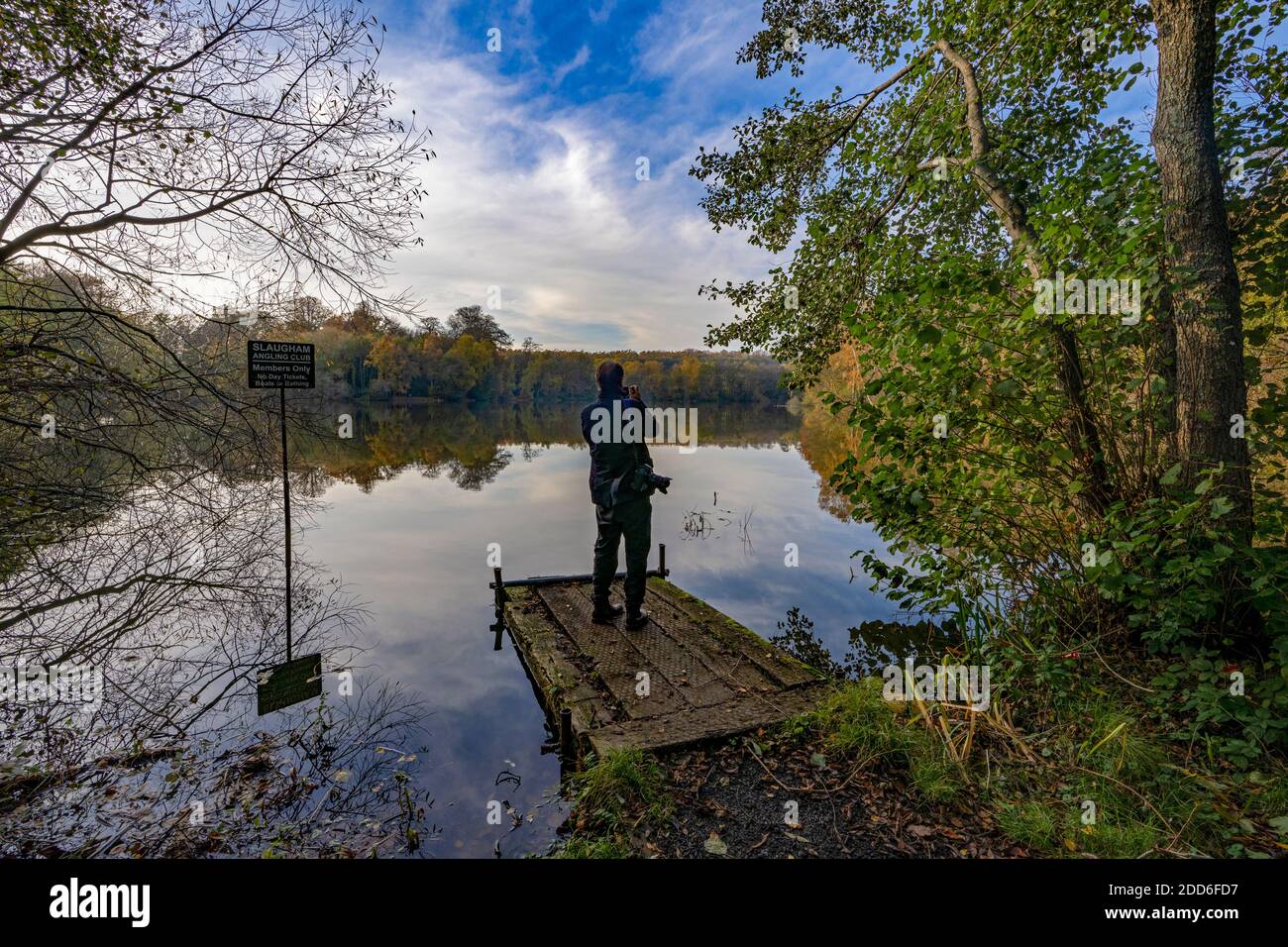 Male photographer photographing Slaugham mill pond, Slaugham, West ...