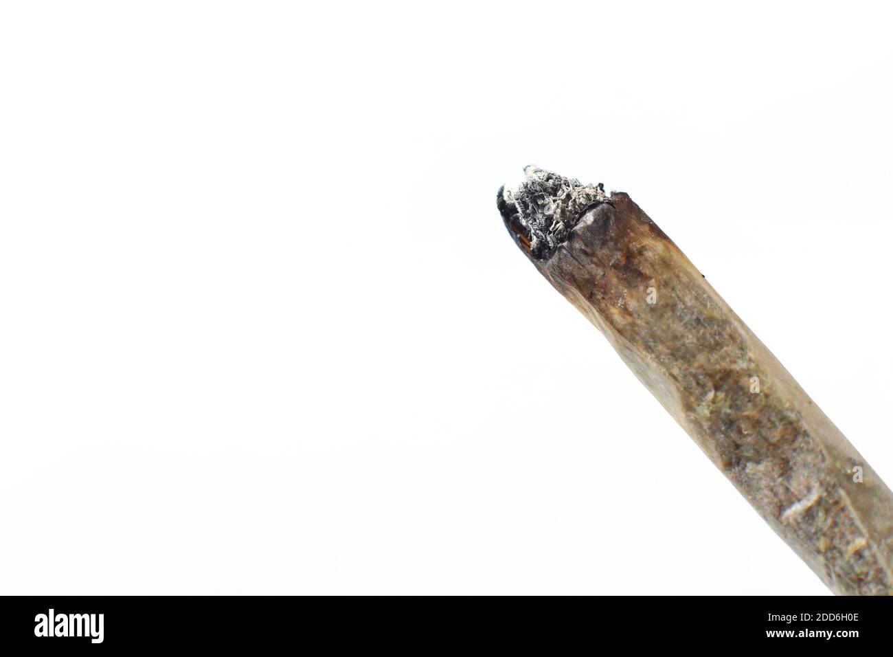 Burning cigarette close up isolated on a white background. Smoking cannabis joint. Medical use ...