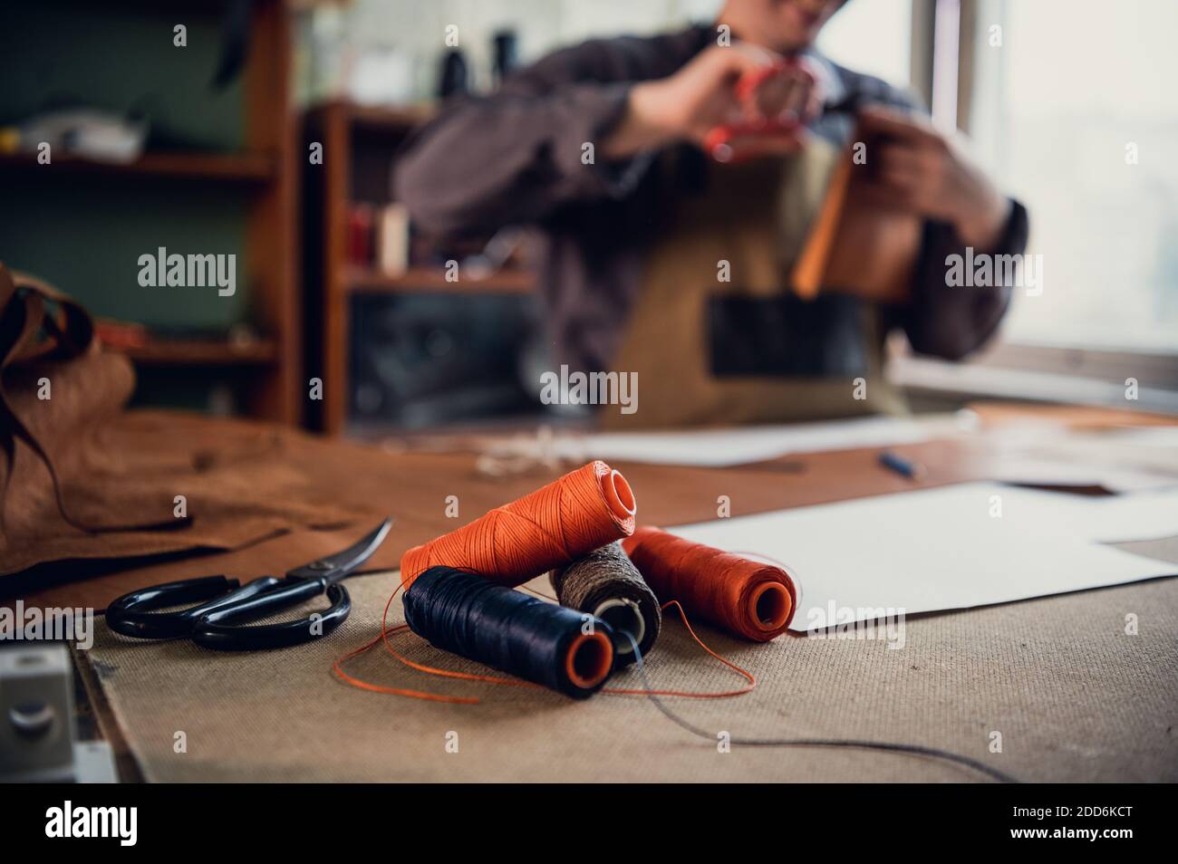 Old school workshop of an exclusive shoemaker. Spools of thread on the ...