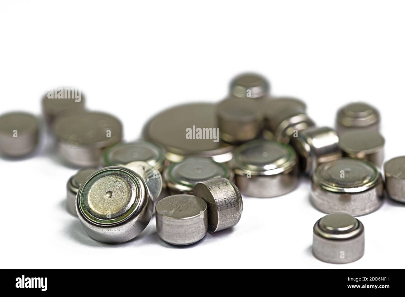 Various button cells against a white background Stock Photo - Alamy