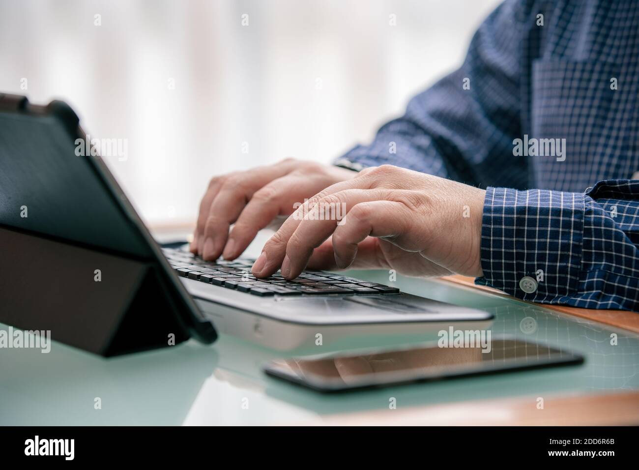 Hands typing computer while teleworking Stock Photo - Alamy