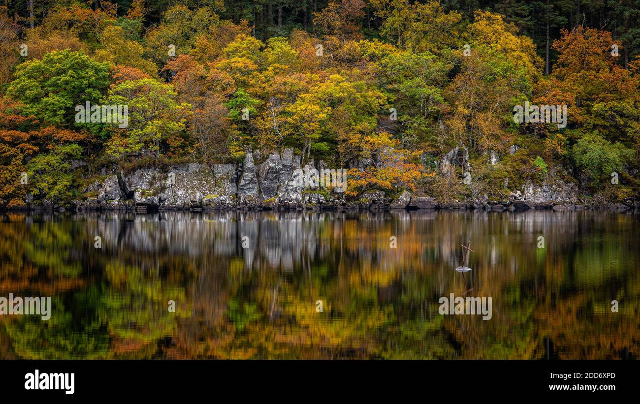 A small iron cross in the Trossachs National park reflecting in the ...