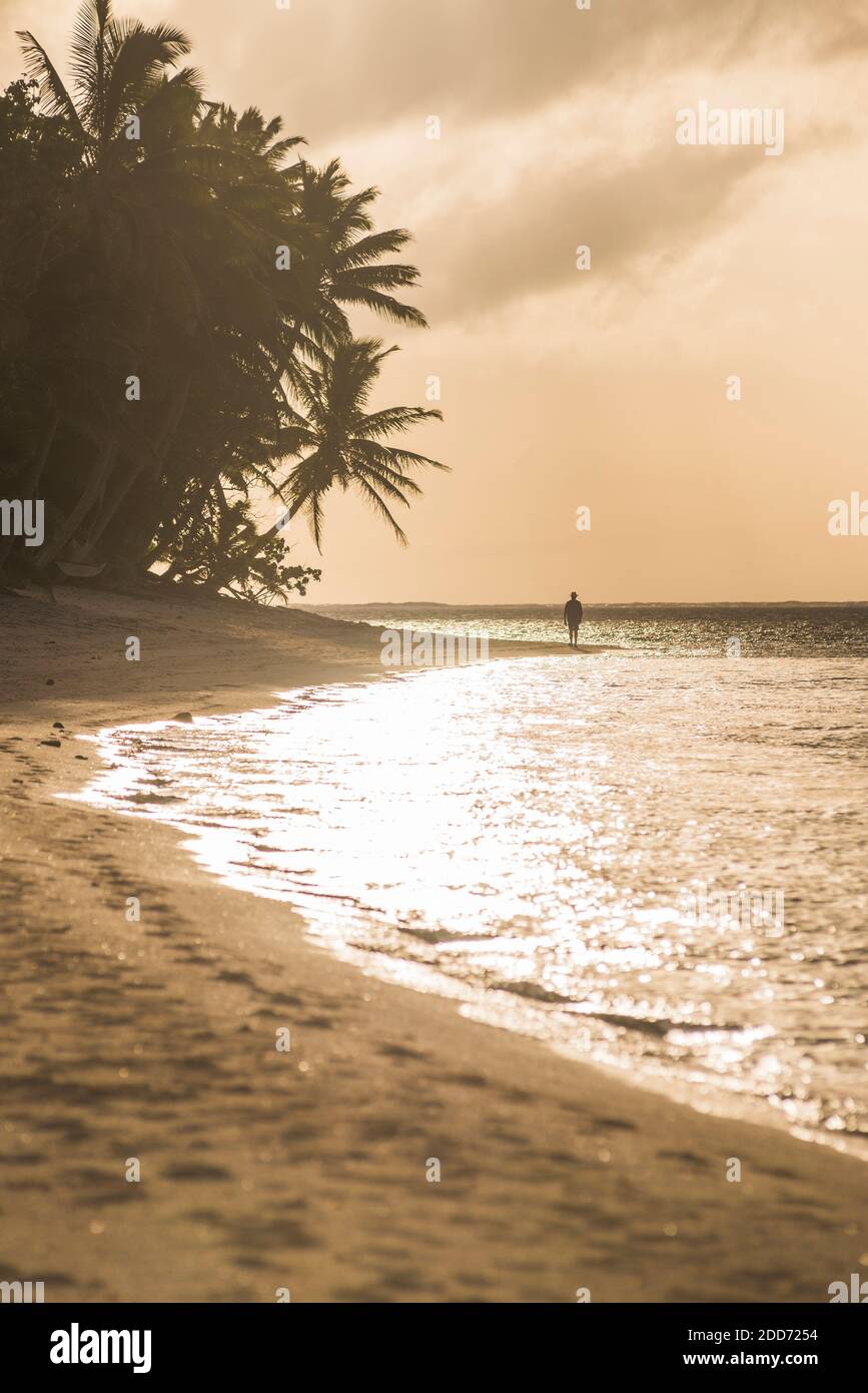 Walking along a tropical beach at sunrise, Titikaveka, Rarotonga, Cook ...