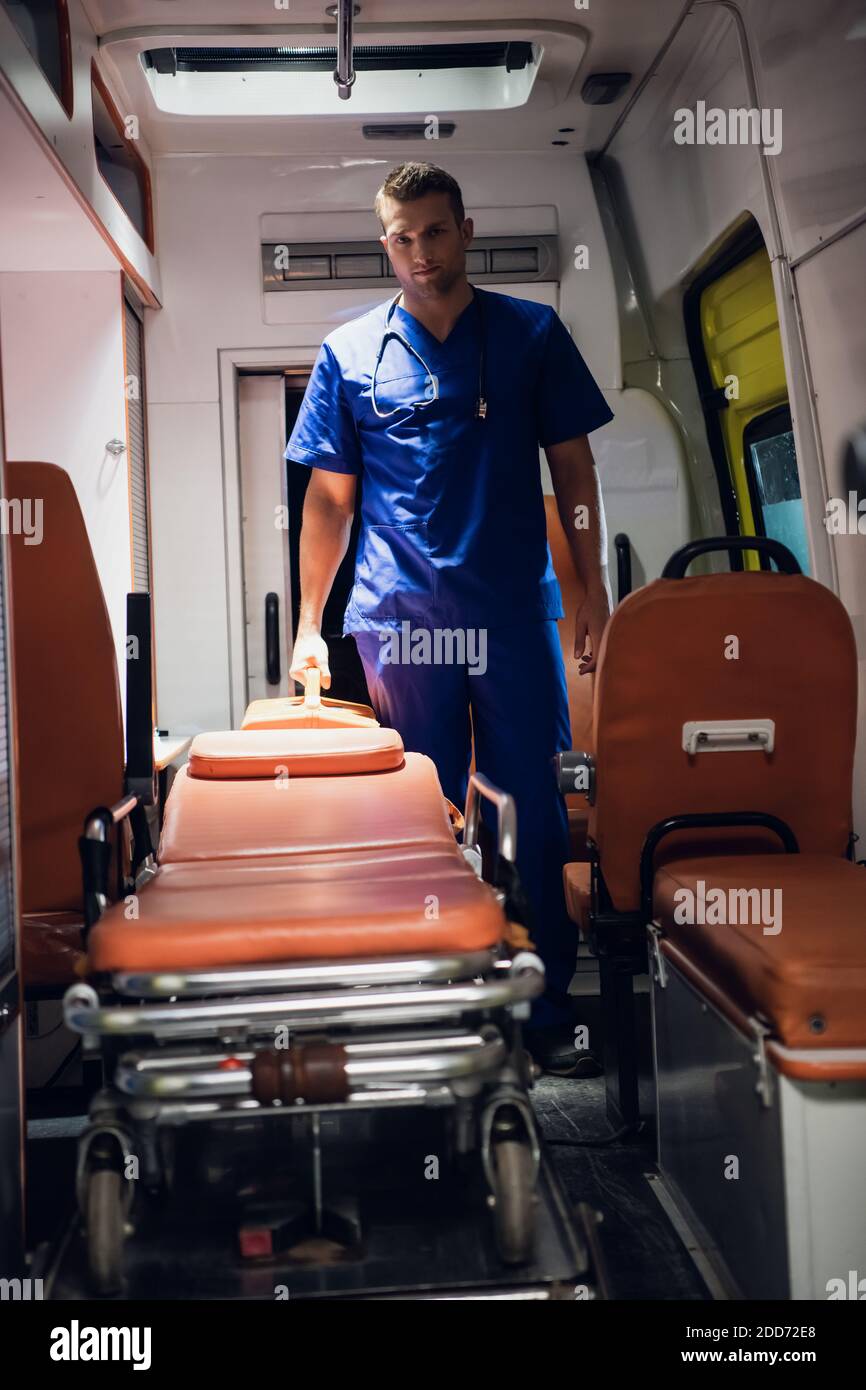 Medical worker on duty, standing in an ambulance car Stock Photo - Alamy
