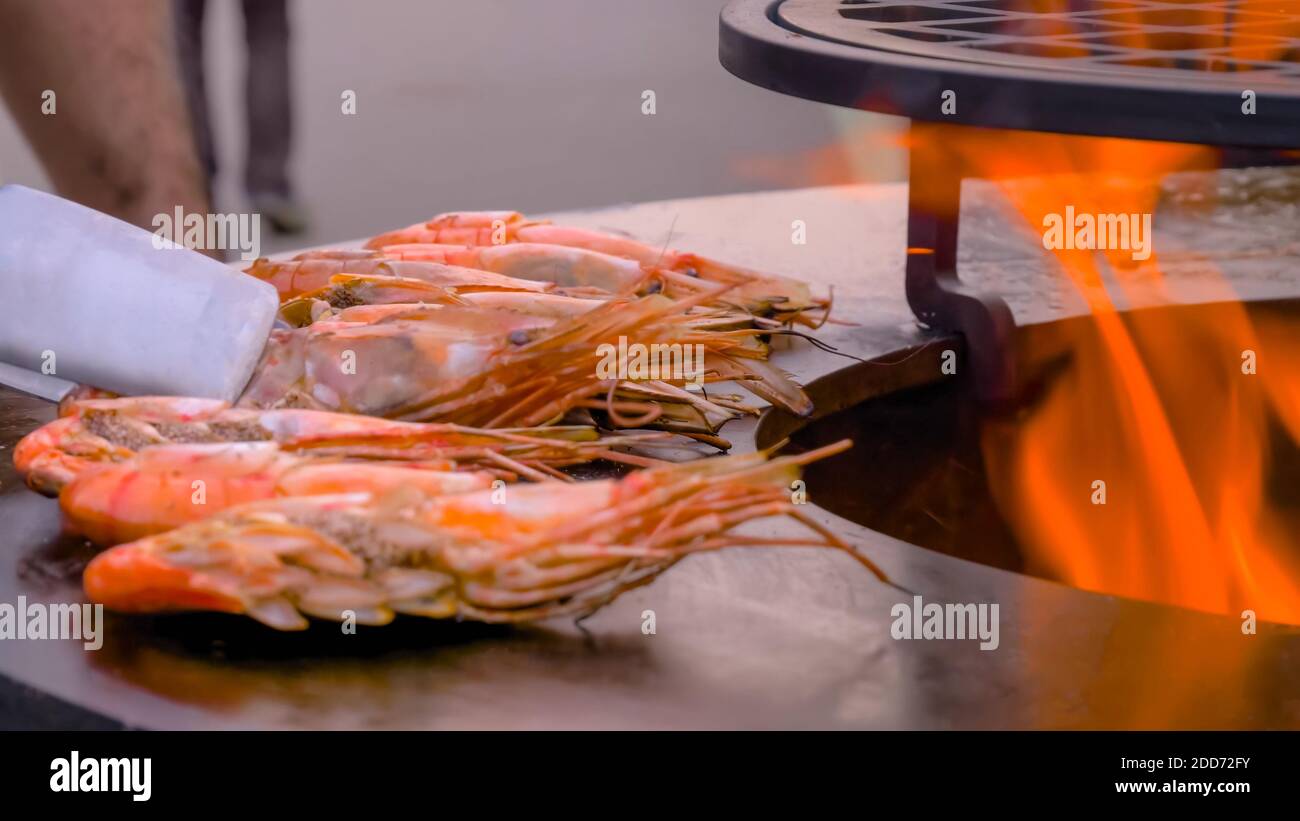 Chef grilling fresh red king prawns on brazier - close up view Stock ...