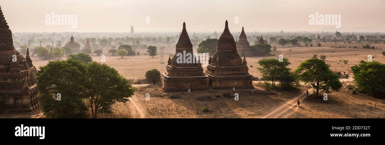 Tourists exploring the Temples of Bagan (Pagan) at sunrise, Myanmar ...