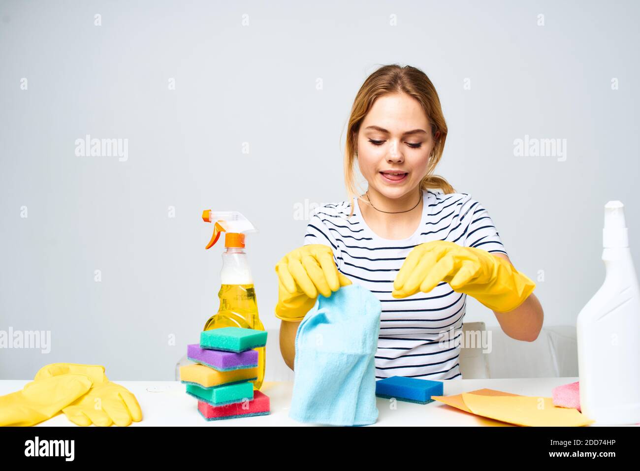 A cleaning lady sits at a table providing housekeeping services light ...