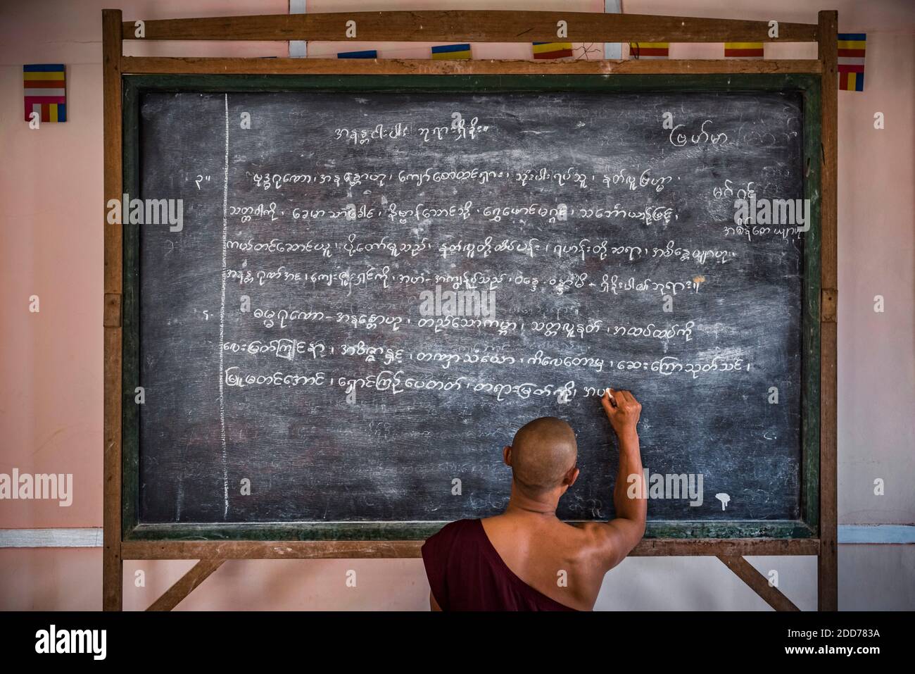 Monk teaching young novice monks at a Buddhist temple at Pindaya, Shan ...