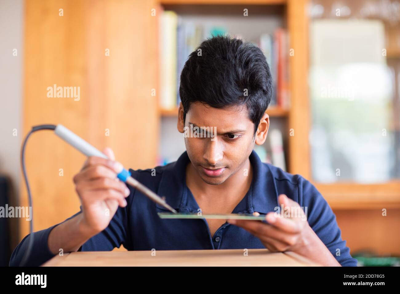 young man student learning to solder Stock Photo - Alamy