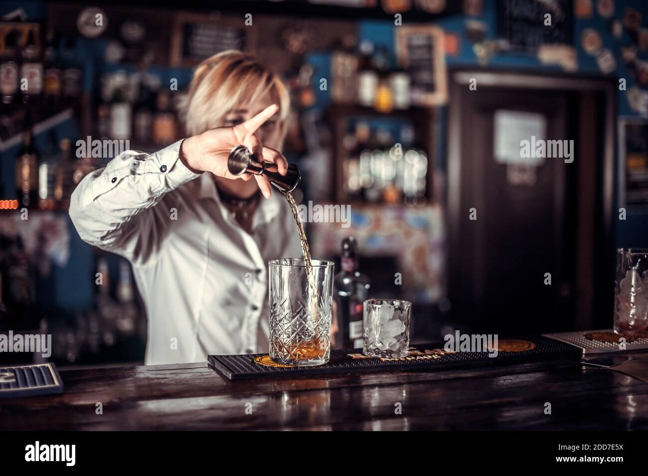 Professional woman bartending creates a cocktail on the bar Stock Photo ...