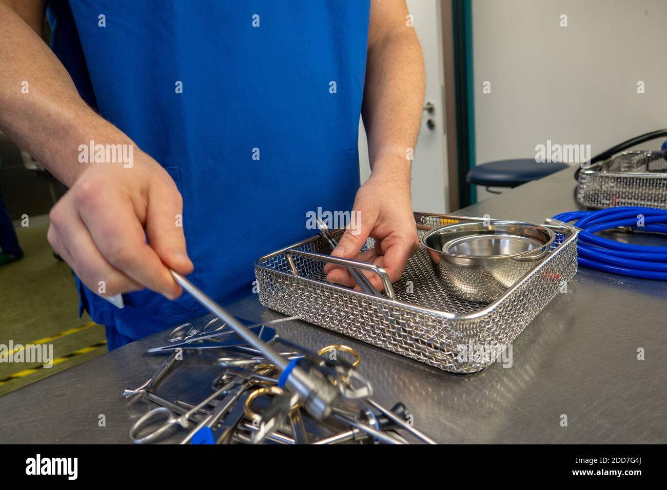 an employee of a hospital sterilization department sorts the cleaned ...