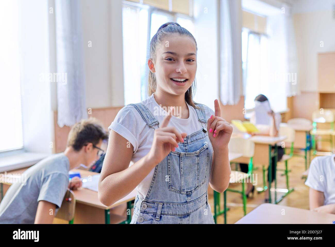 Teenage student answers lesson, classroom with study students ...