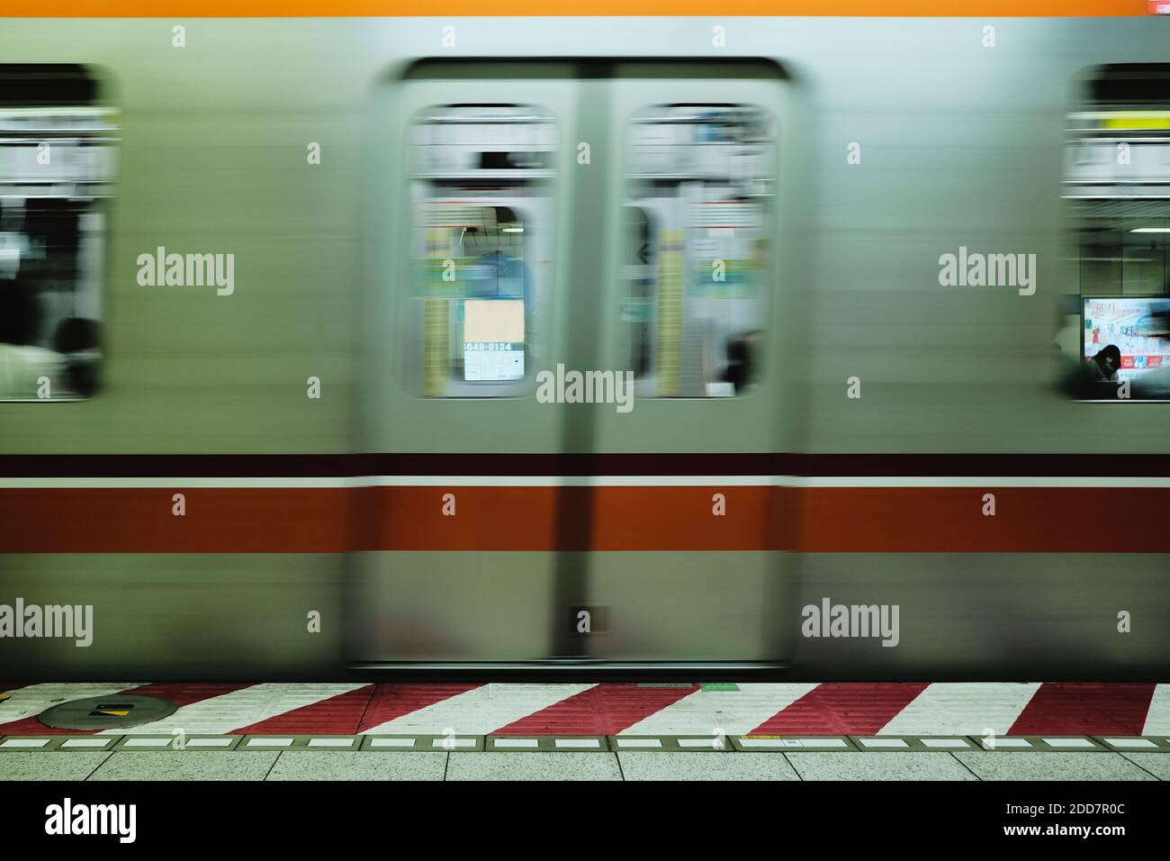 Subway train leaving from a station in Tokyo, Japan Stock Photo - Alamy