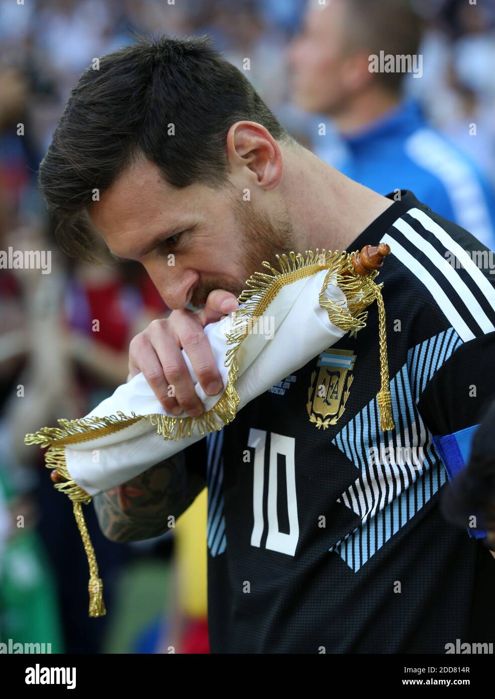Lionel Messi, the captain of Argentina, coming out to the pitch kissing ...