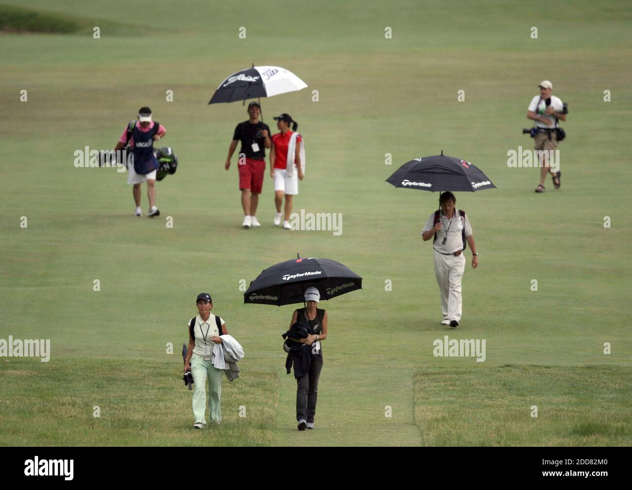 NO FILM, NO VIDEO, NO TV, NO DOCUMENTARY - Golfers, caddies and fans ...