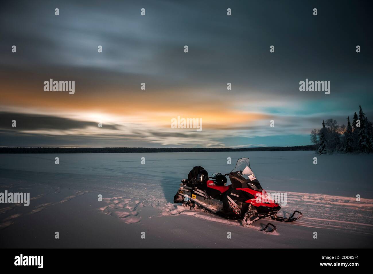 Snow mobiling on a snow mobile in Finnish Lapland at night on an ...