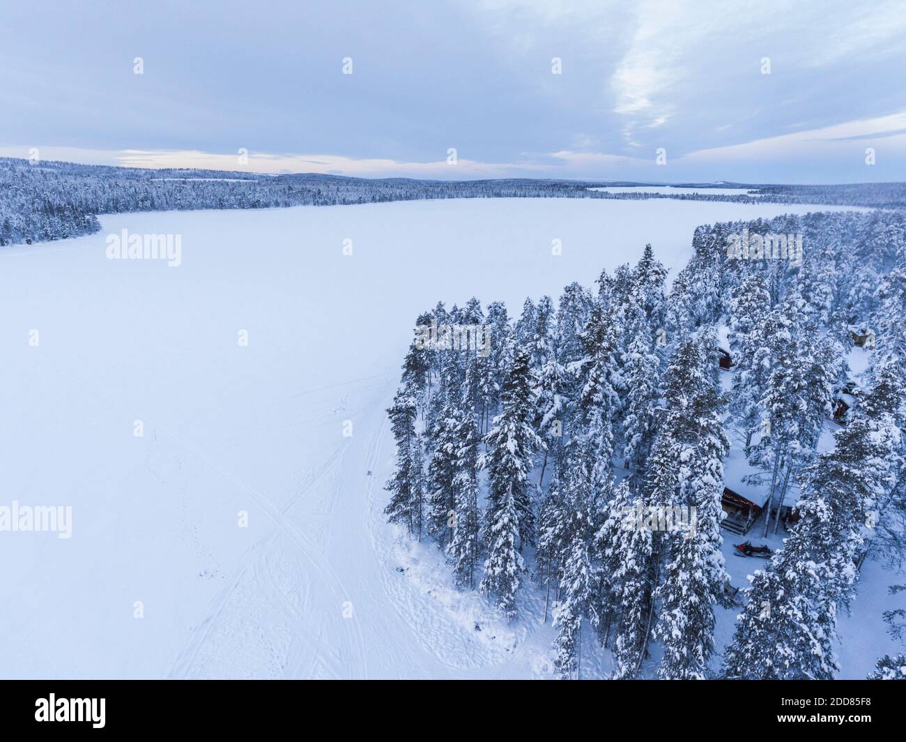 Snow covered lake and forest winter landscape showing amazing Lapland ...