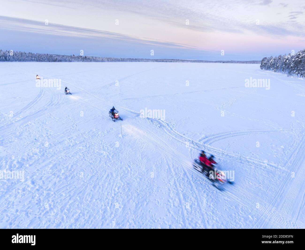 Snow mobiles on a snow mobiling adventure on a snow covered frozen lake ...