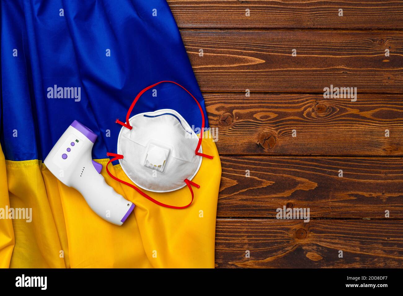 Medical mask and contactless thermometer on the flag of Ukraine Stock ...