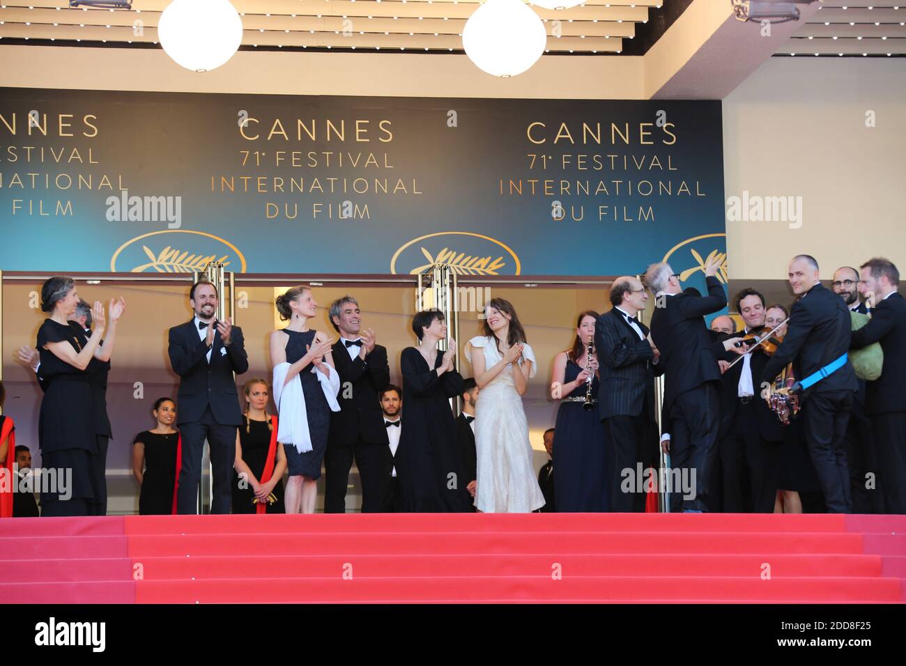 Singer Camille dances as musicians play on the red carpet before the ...