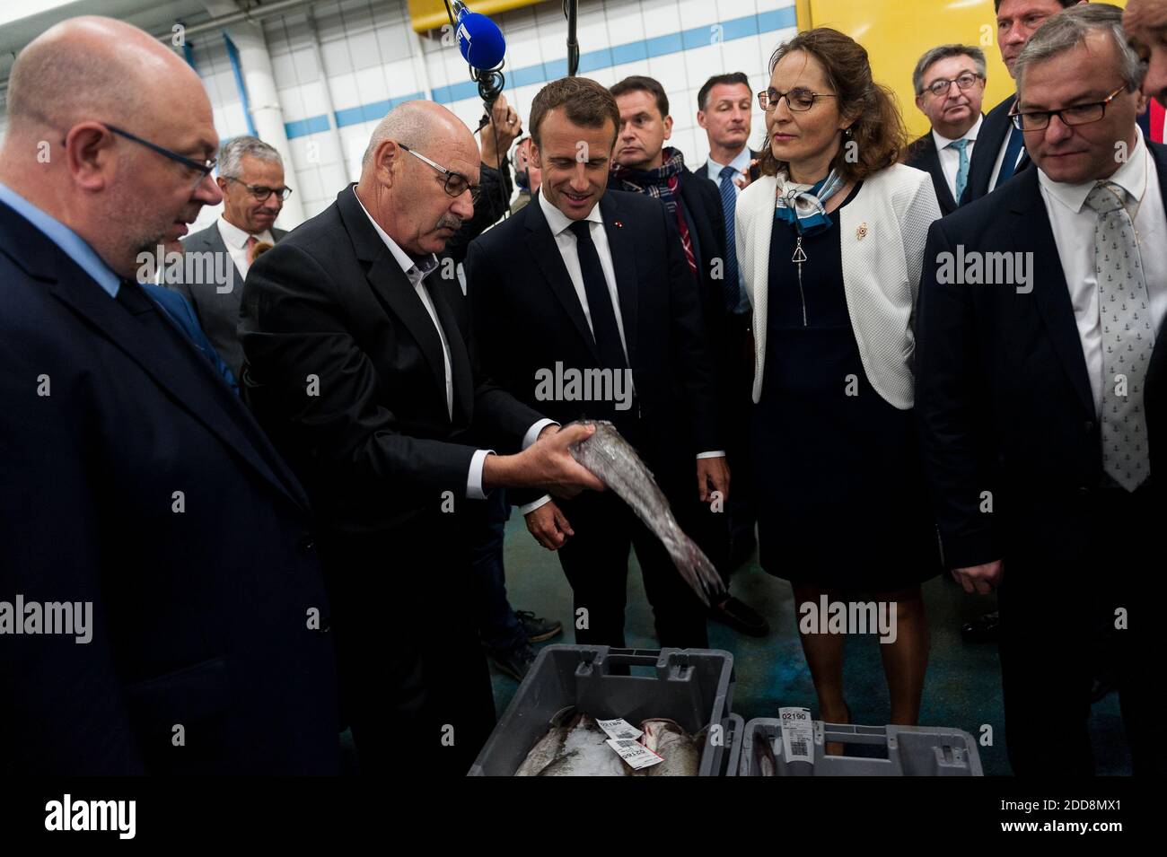 French President Emmanuel Macron visits the fish market on June 21 ...